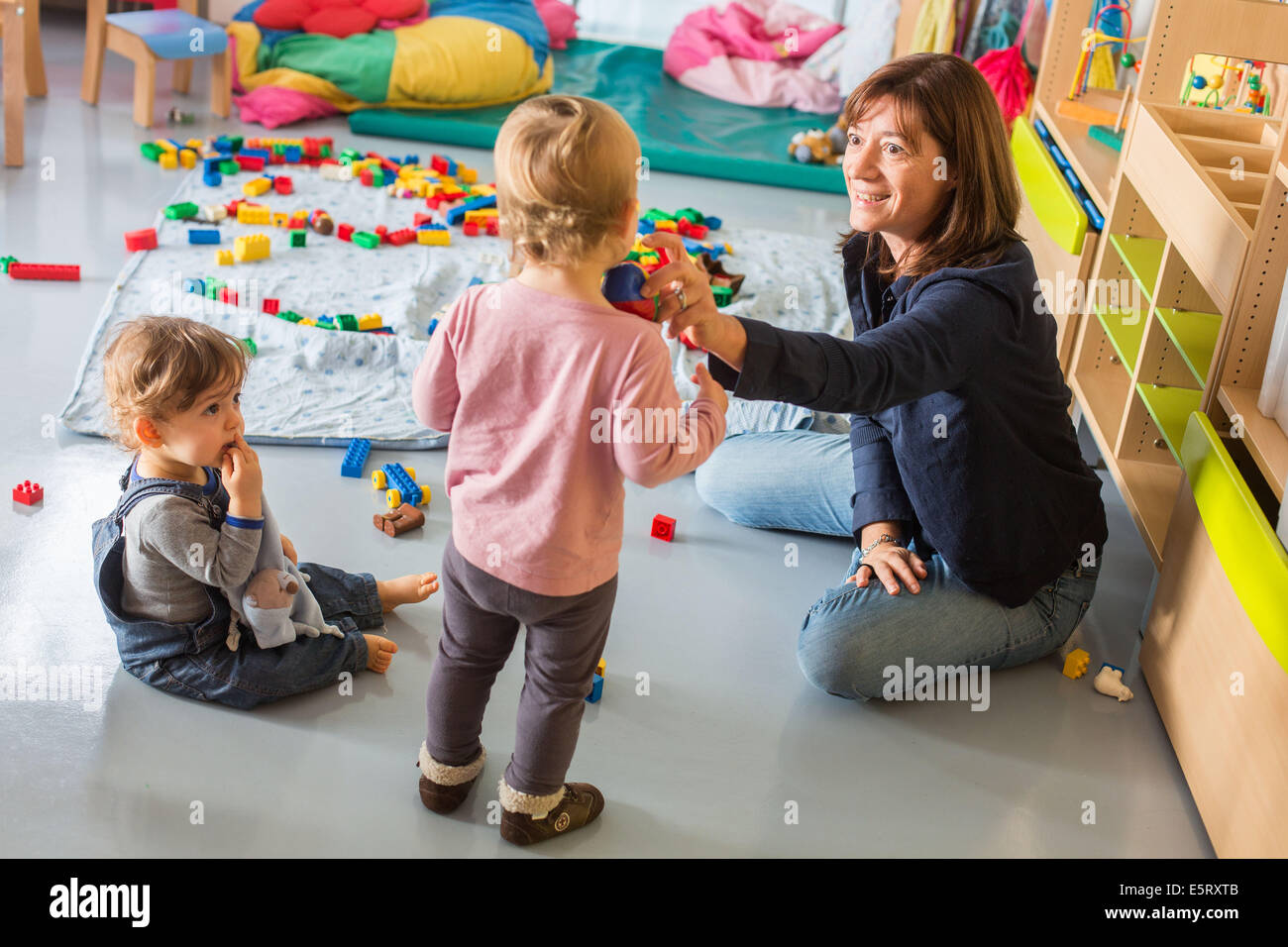 Psychomotricity specialist with children. Shared playroom of day ...