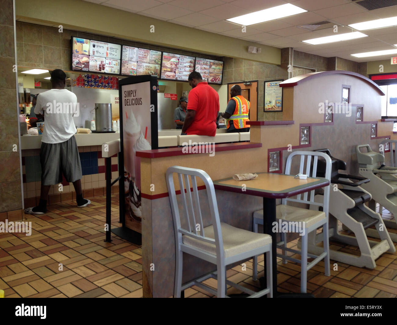 People waiting at the counter for their food at a fast food restaurant ...