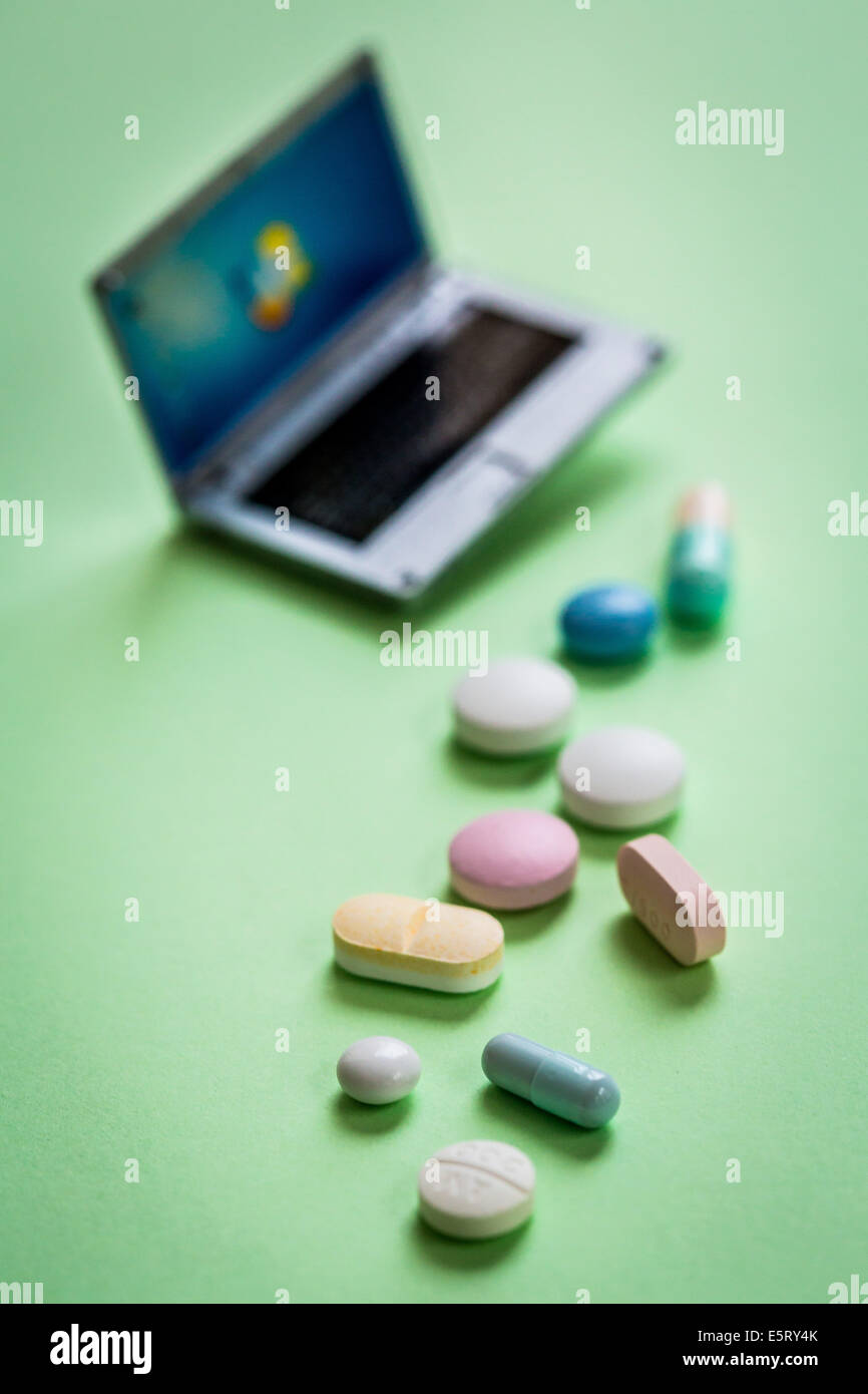 Drugs on a computer keyboard to illustrate buying medicines online ...