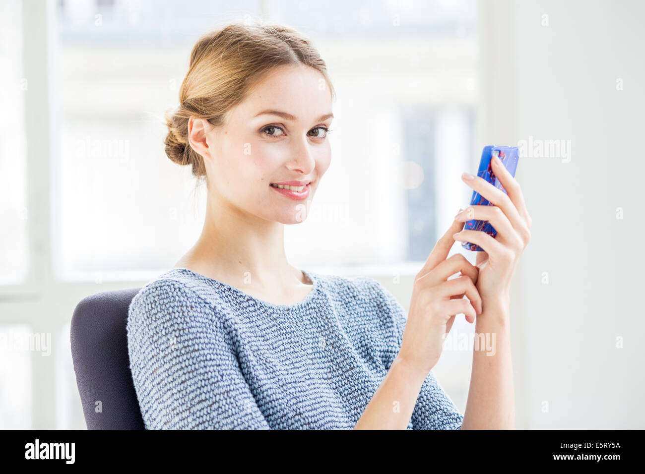 Woman touching the screen of an iphone® Stock Photo - Alamy