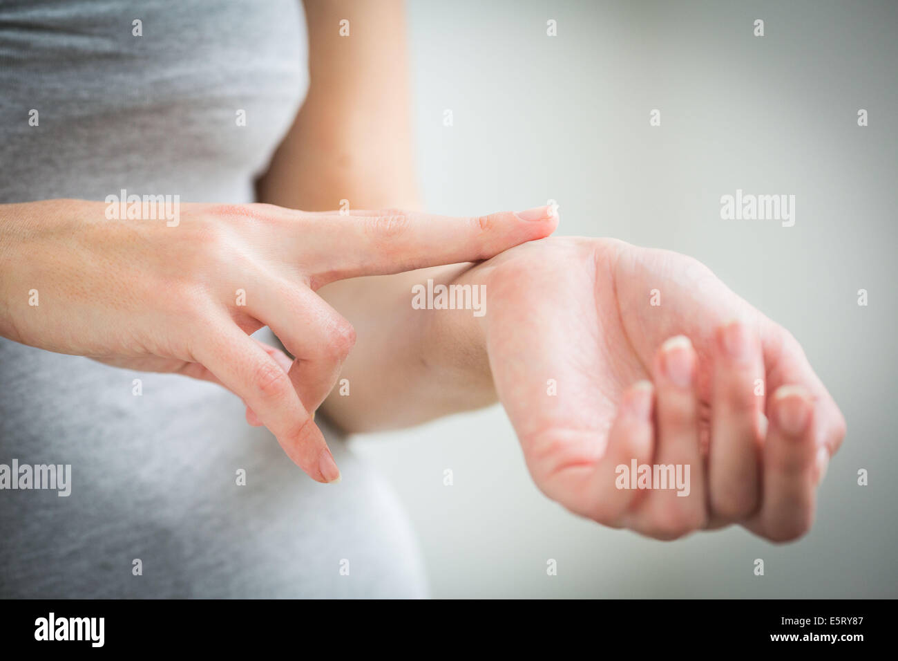 Woman checking pulse Stock Photo - Alamy