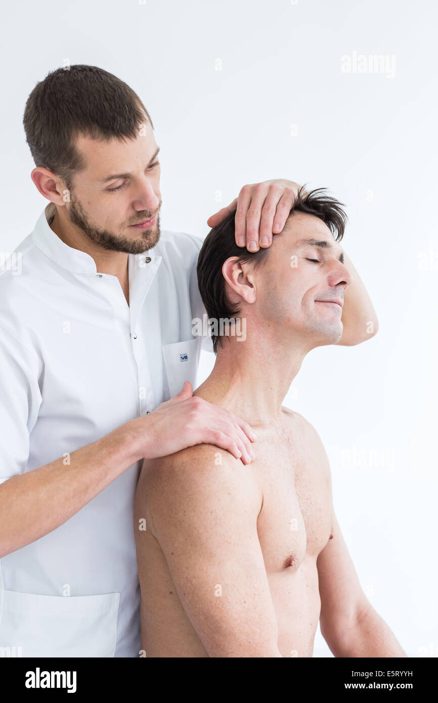Structural osteopathy session in a man suffering from neck pain Stock ...