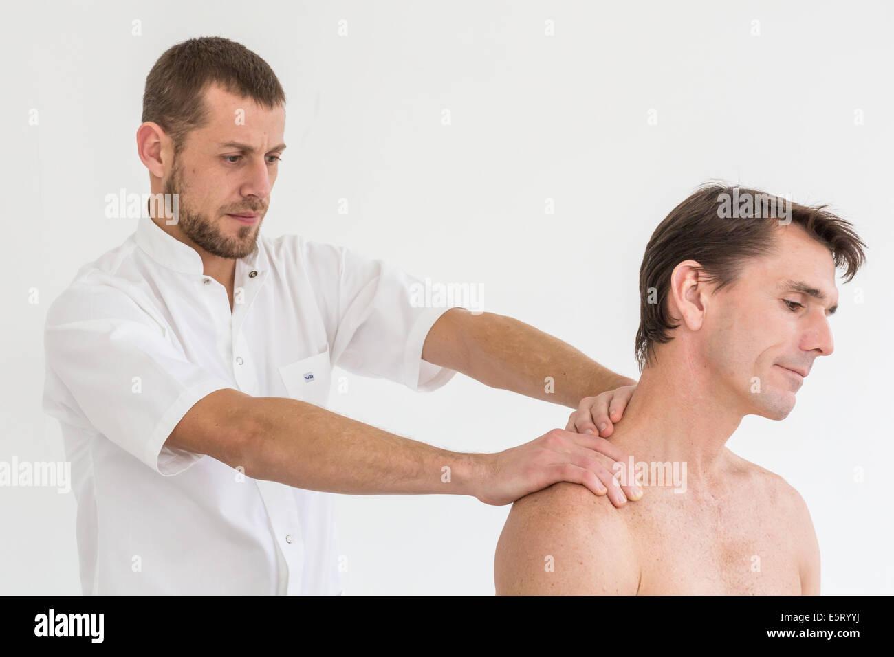 Structural osteopathy session in a man suffering from neck pain Stock ...