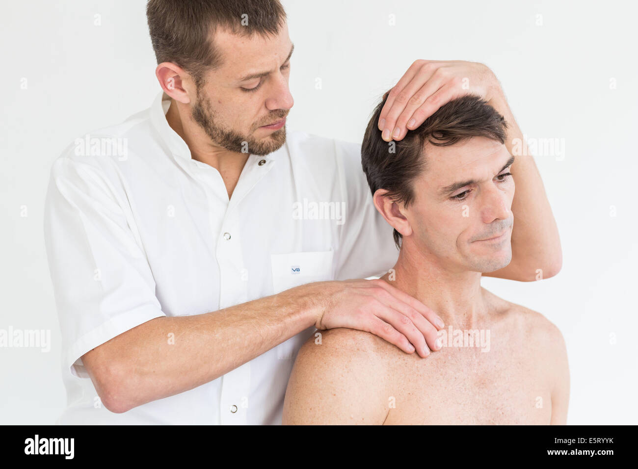 Structural osteopathy session in a man suffering from neck pain Stock ...