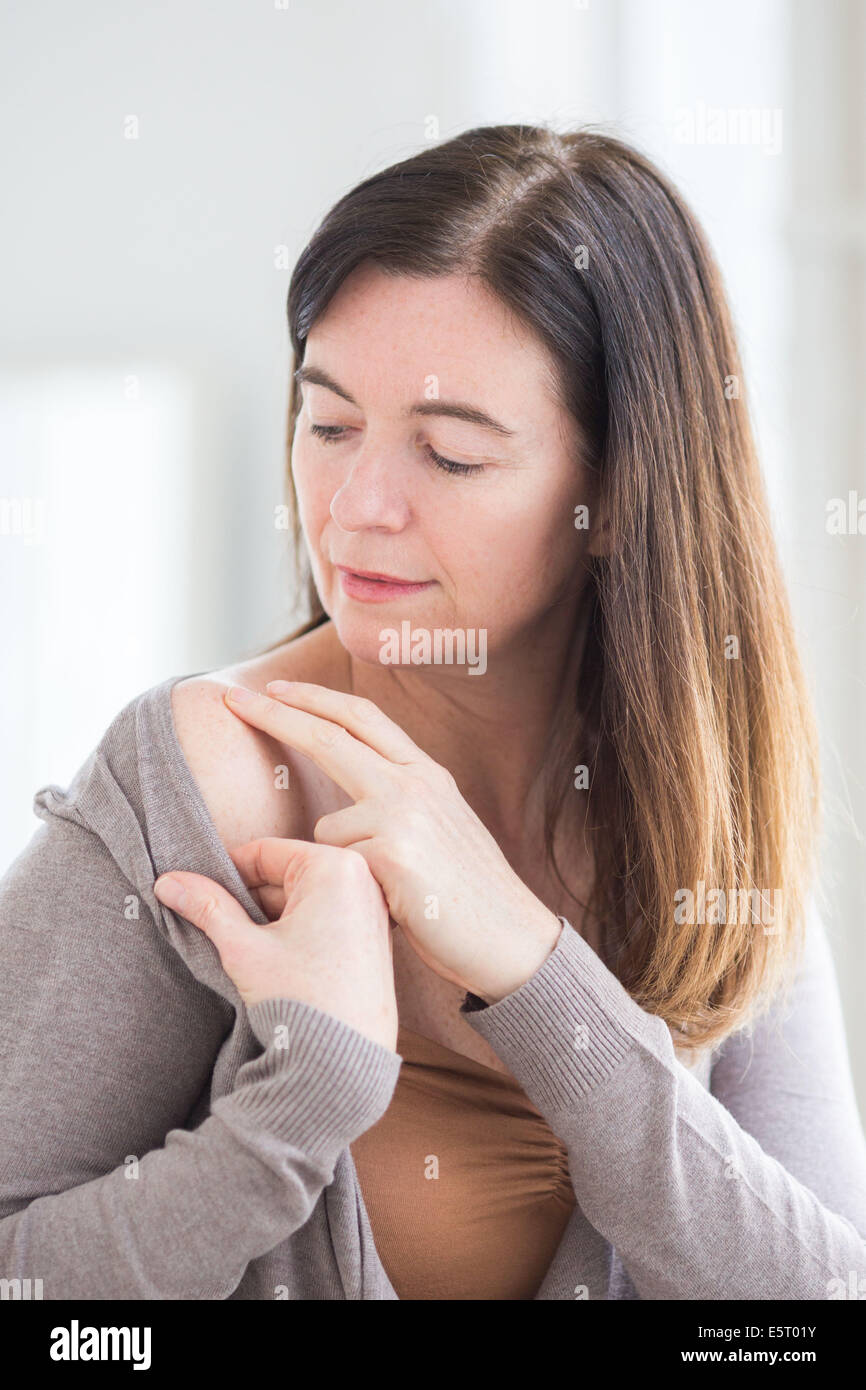 Woman inspecting her skin Stock Photo - Alamy