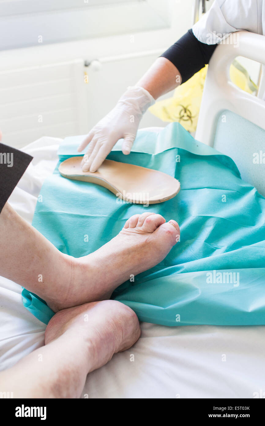 Podiatrist examining foot patient hi-res stock photography and images ...
