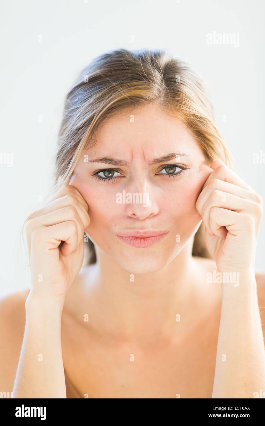 Woman stretching the skin of her face Stock Photo - Alamy