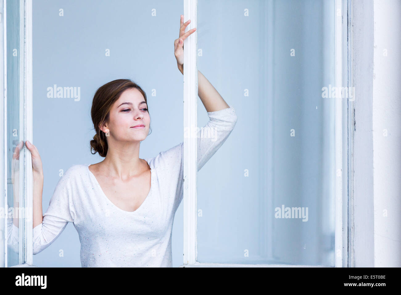 Woman opening window Stock Photo - Alamy