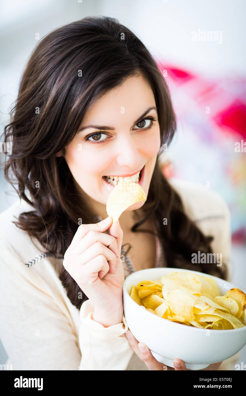 Woman eating potato chips Stock Photo - Alamy