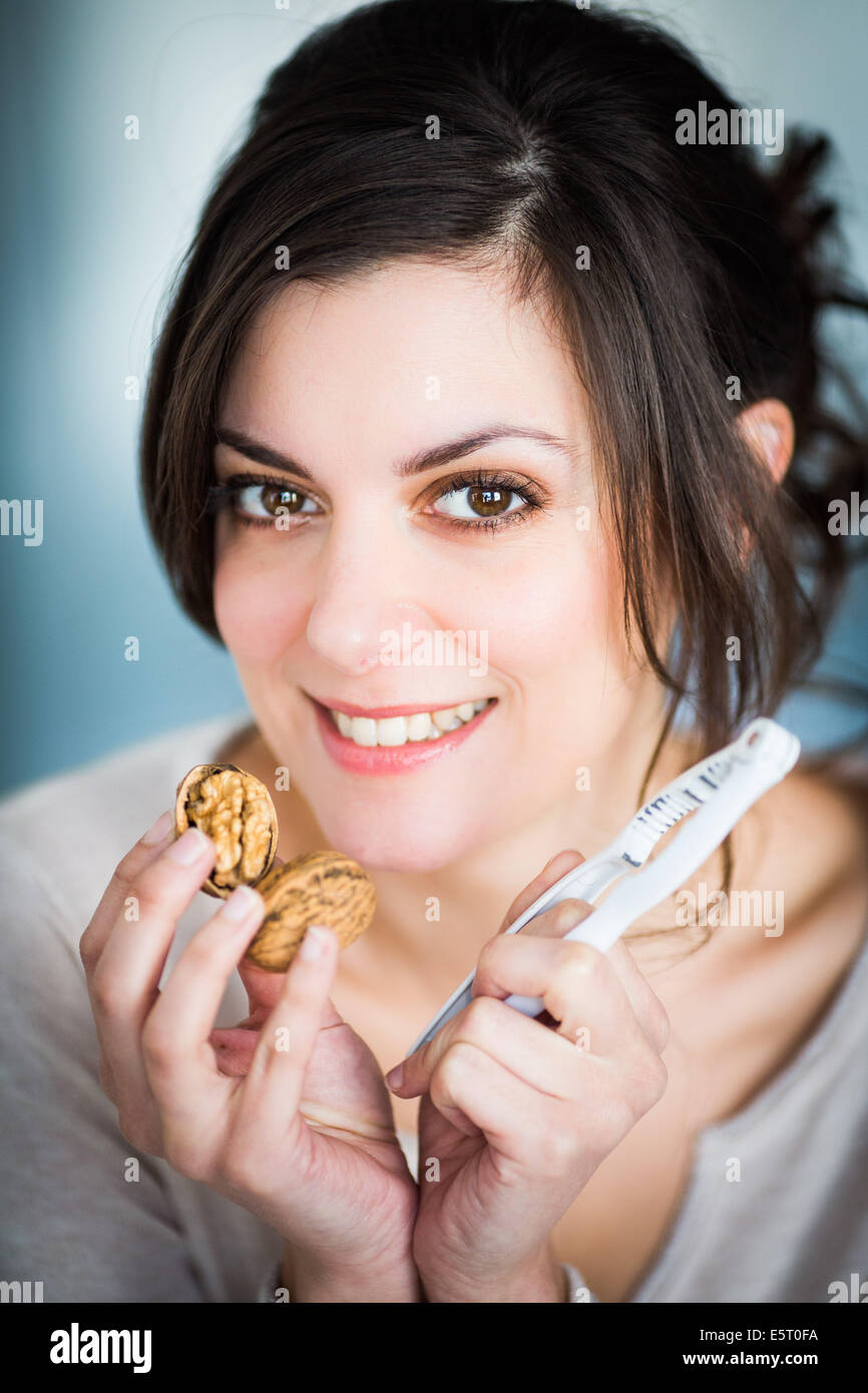 Woman eating walnuts Stock Photo - Alamy