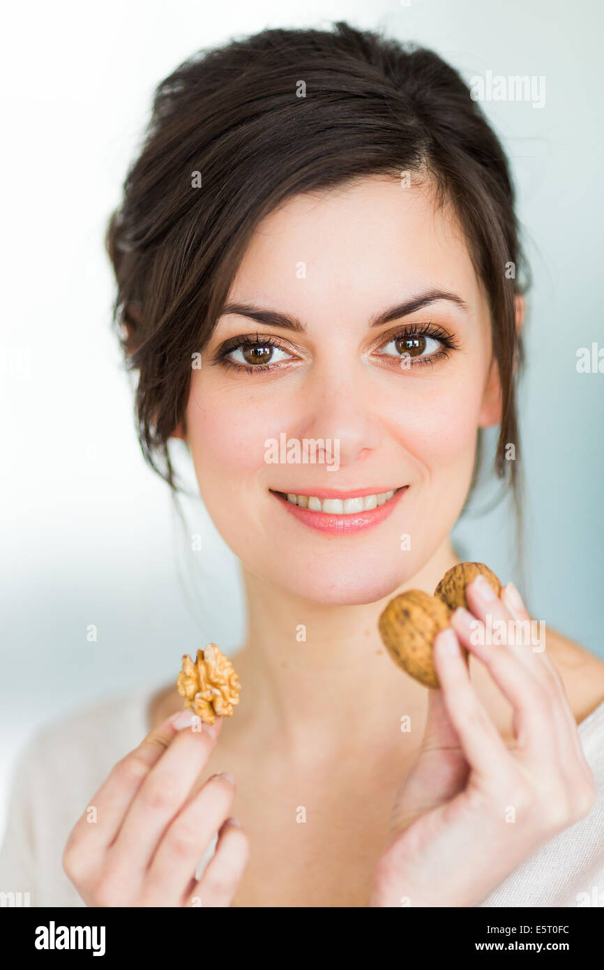 Woman eating walnuts Stock Photo - Alamy