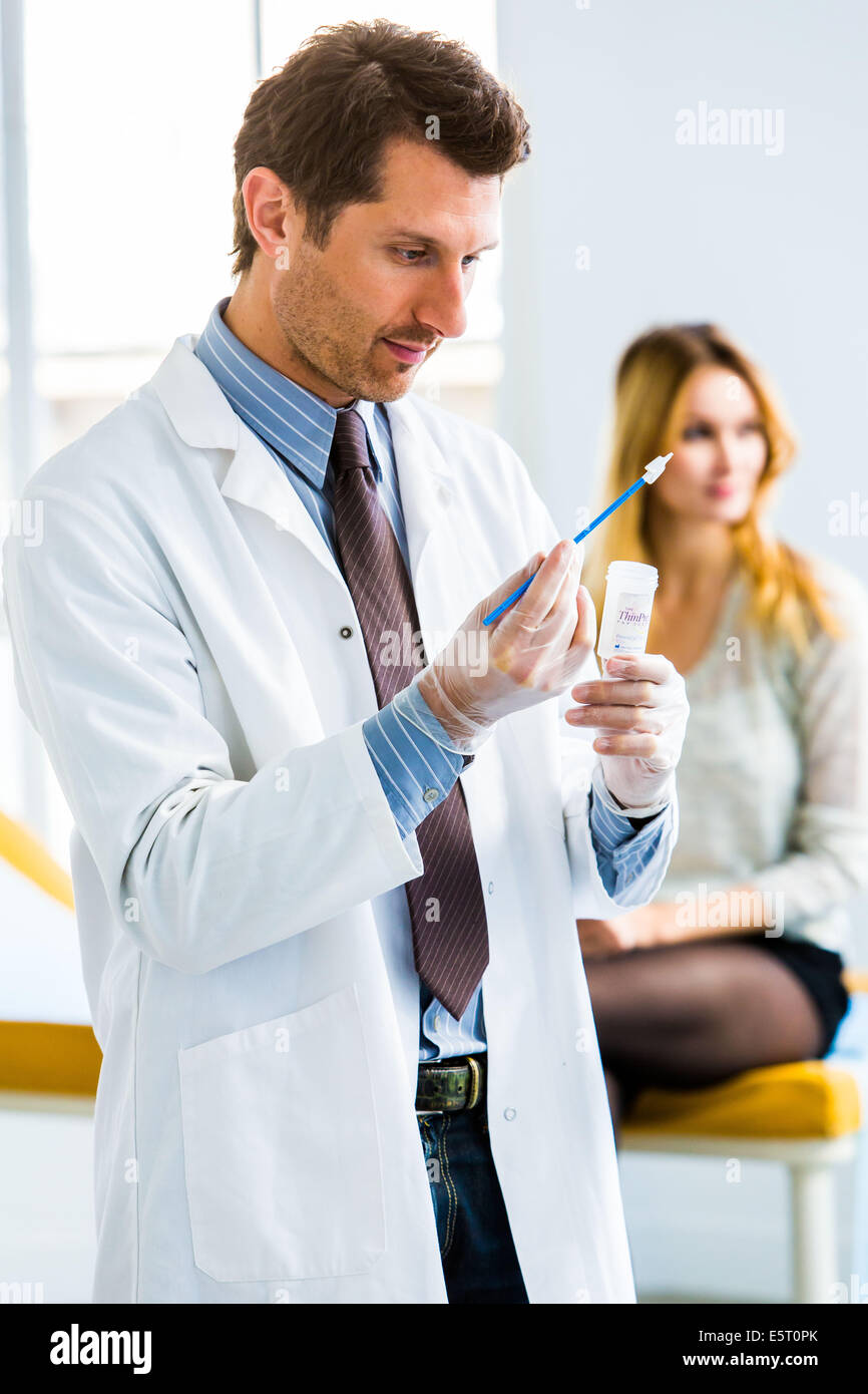 Gynecologist performing a cervical smear or pap test on a female ...
