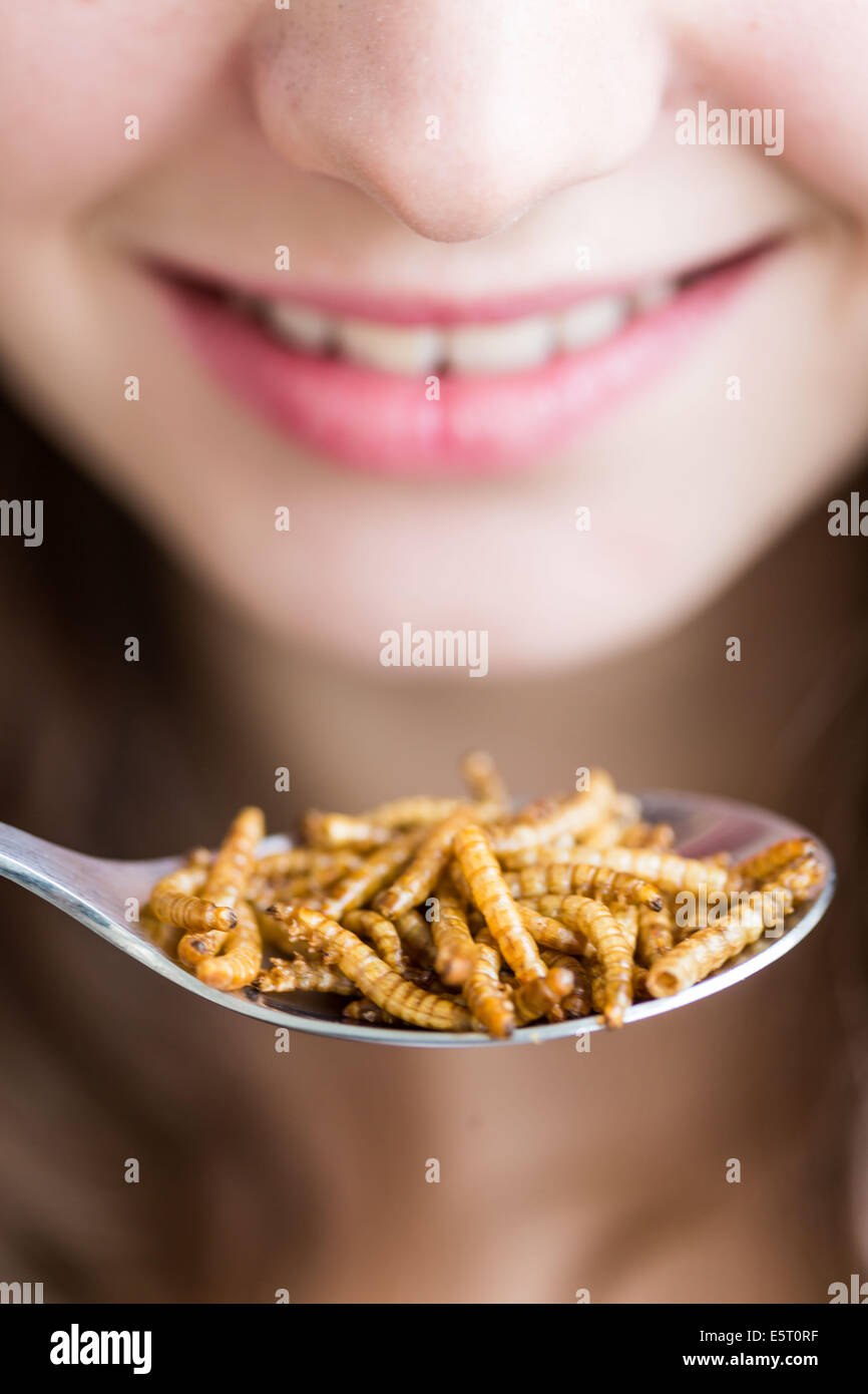 Woman eating edible maggot flour Stock Photo - Alamy