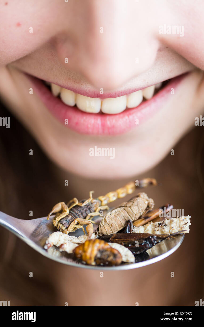 Woman eating edible insects Stock Photo - Alamy