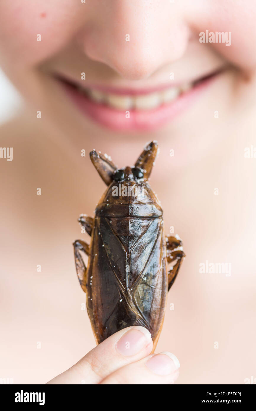 Woman eating an edible Toe biter Stock Photo - Alamy