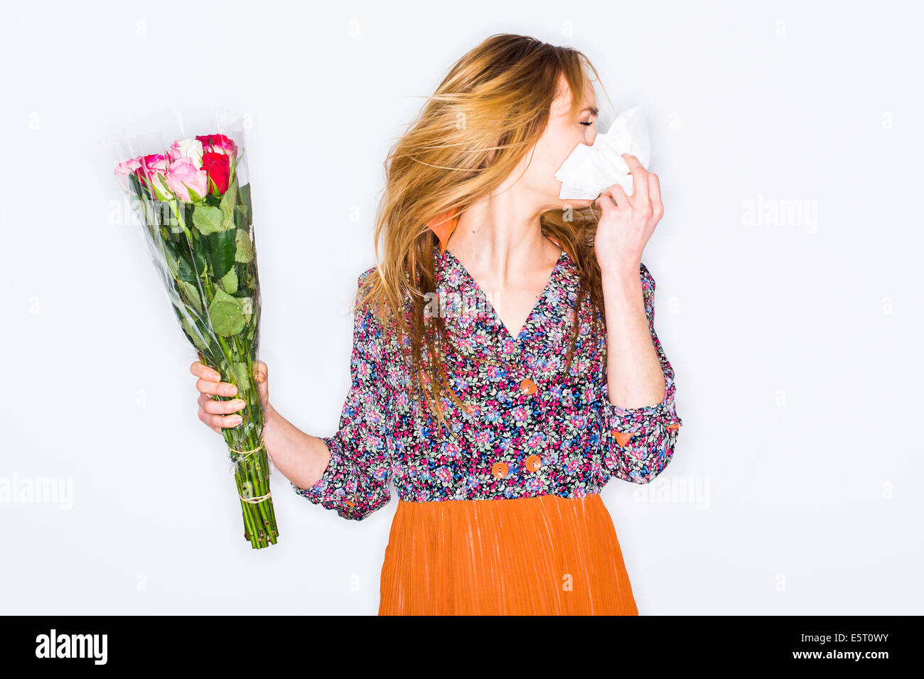 Woman sneezing into a handkerchief Stock Photo - Alamy