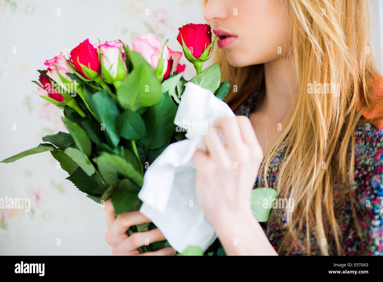 Woman smelling roses Stock Photo - Alamy