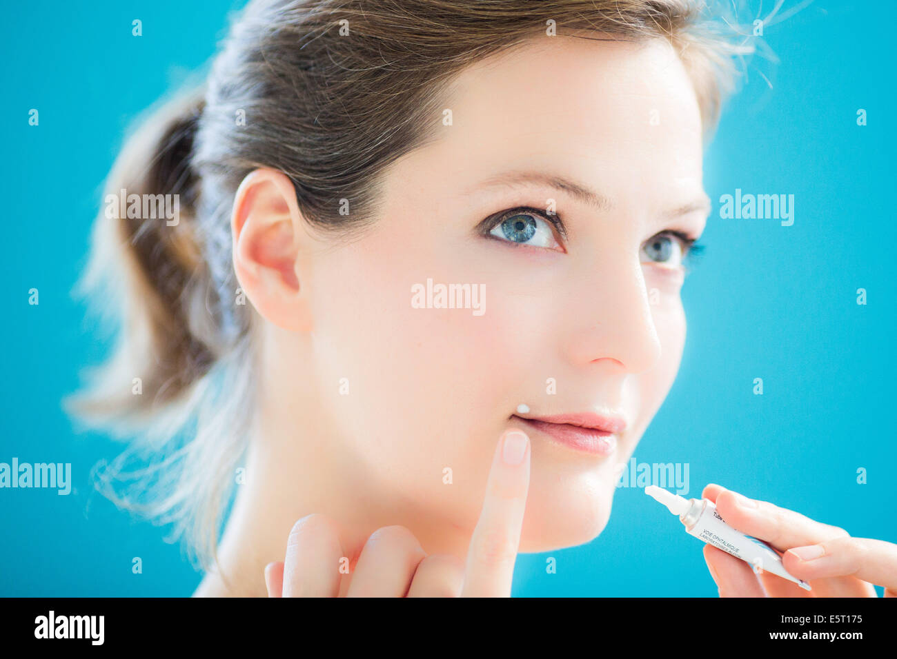 Woman applying ointment on lips hi-res stock photography and images - Alamy