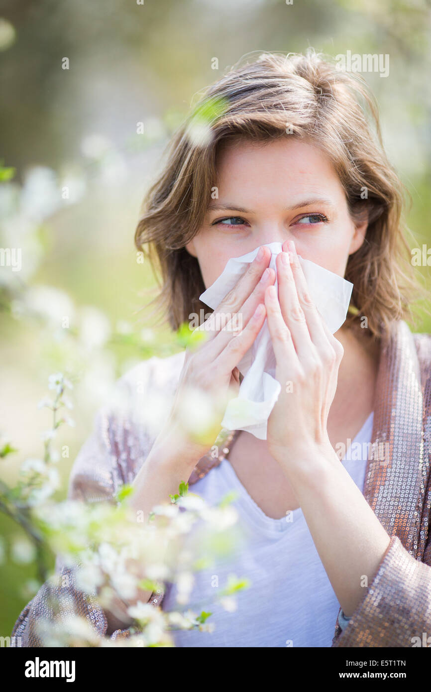 Woman with hay fever blowing her nose Stock Photo - Alamy