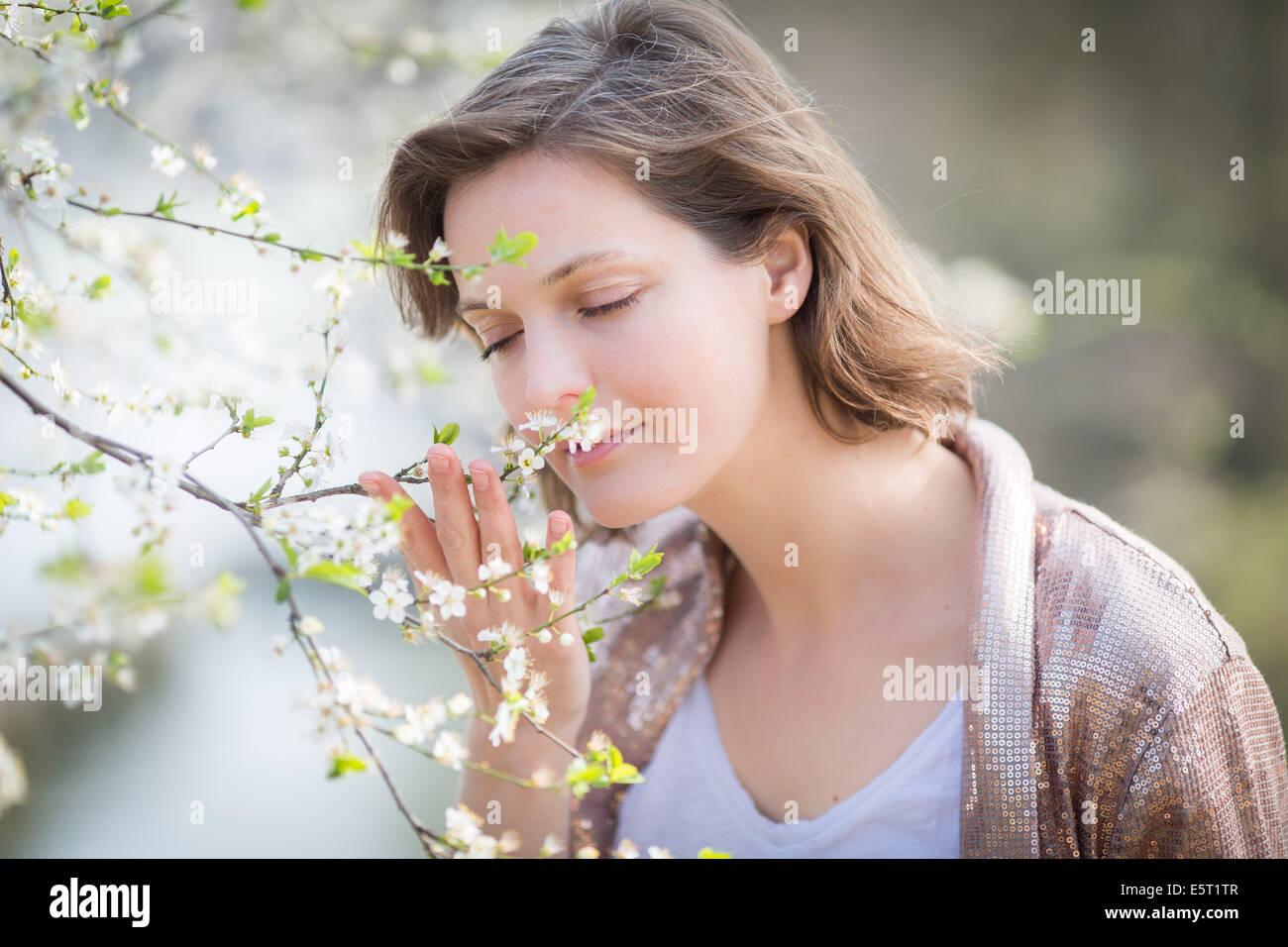 Woman smelling flowers Stock Photo - Alamy