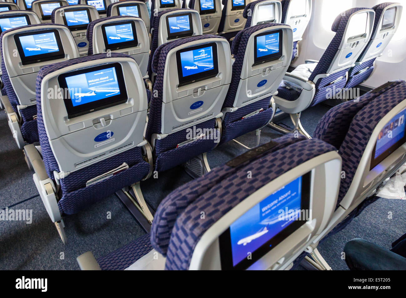 Economy class seating on plane Stock Photo - Alamy