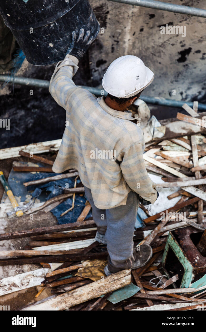 Worker on a construction site of a building Stock Photo - Alamy