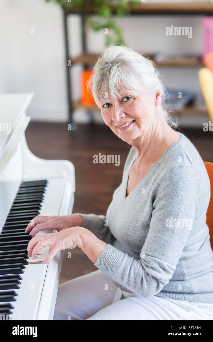 Woman playing piano Stock Photo - Alamy