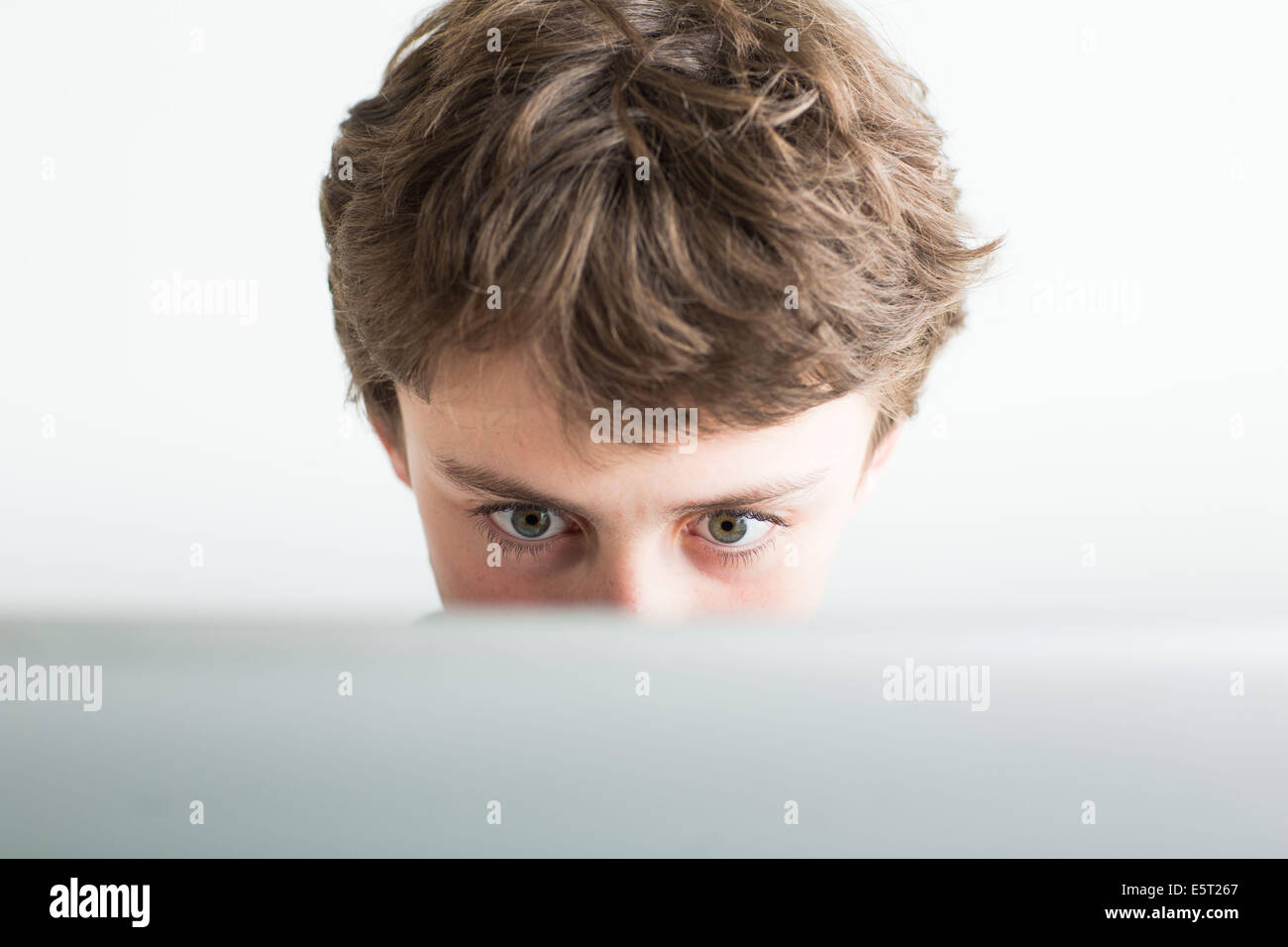 Teenage boy using laptop computer Stock Photo - Alamy