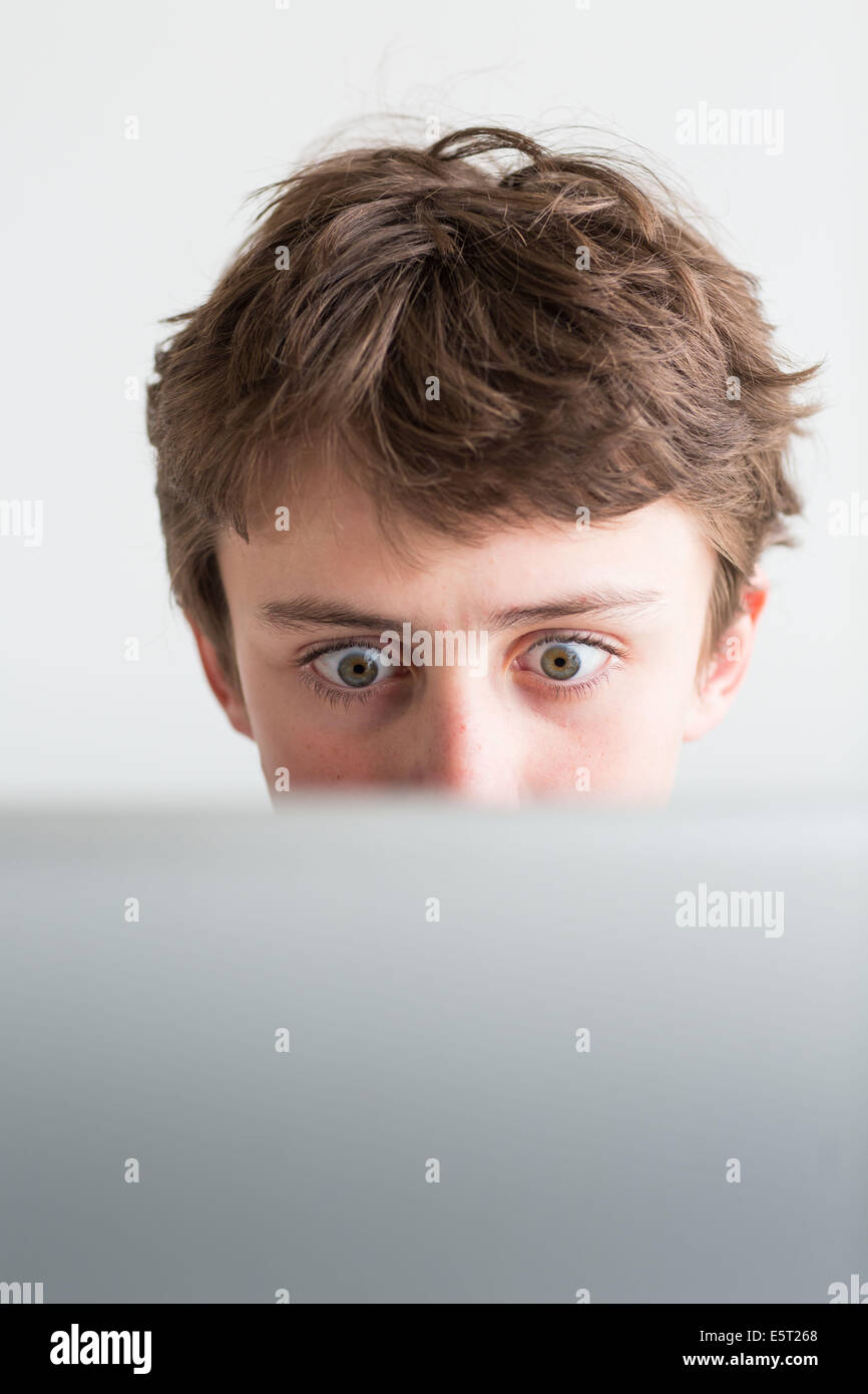 Teenage boy using laptop computer Stock Photo - Alamy