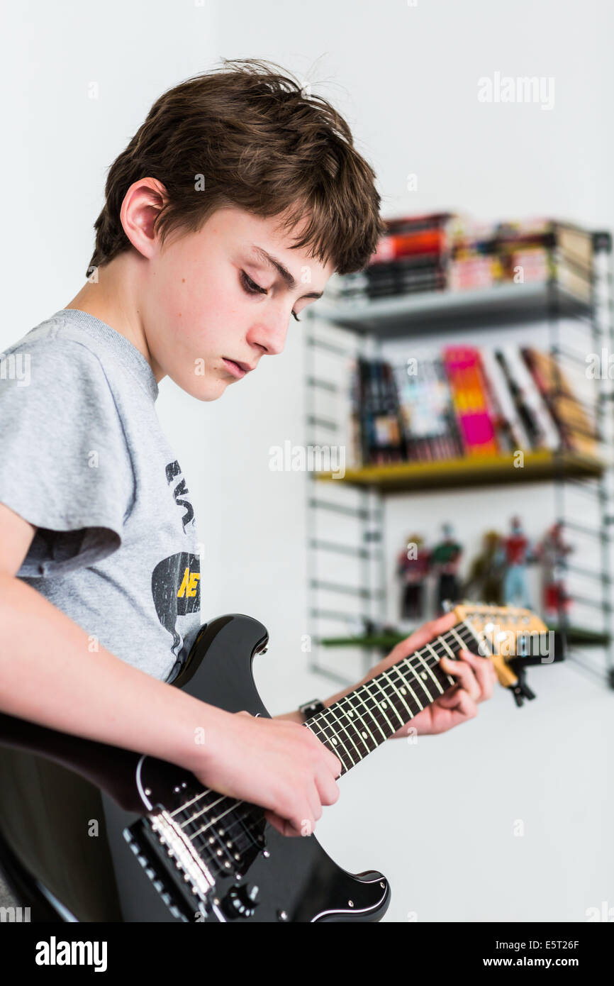Teenage boy playing electric guitar Stock Photo - Alamy