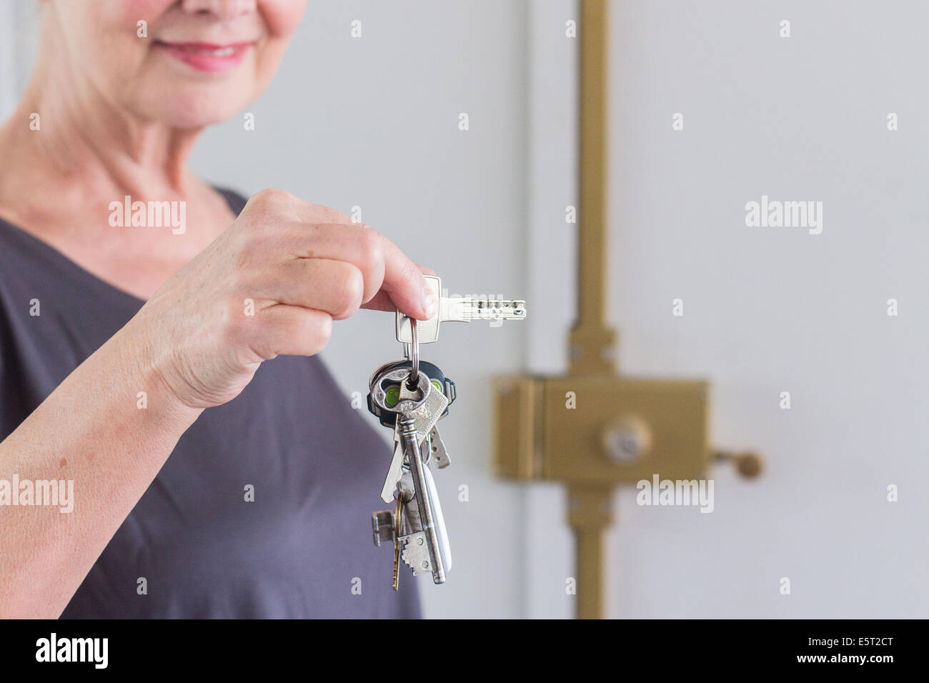 Senior woman door lock hi-res stock photography and images - Alamy