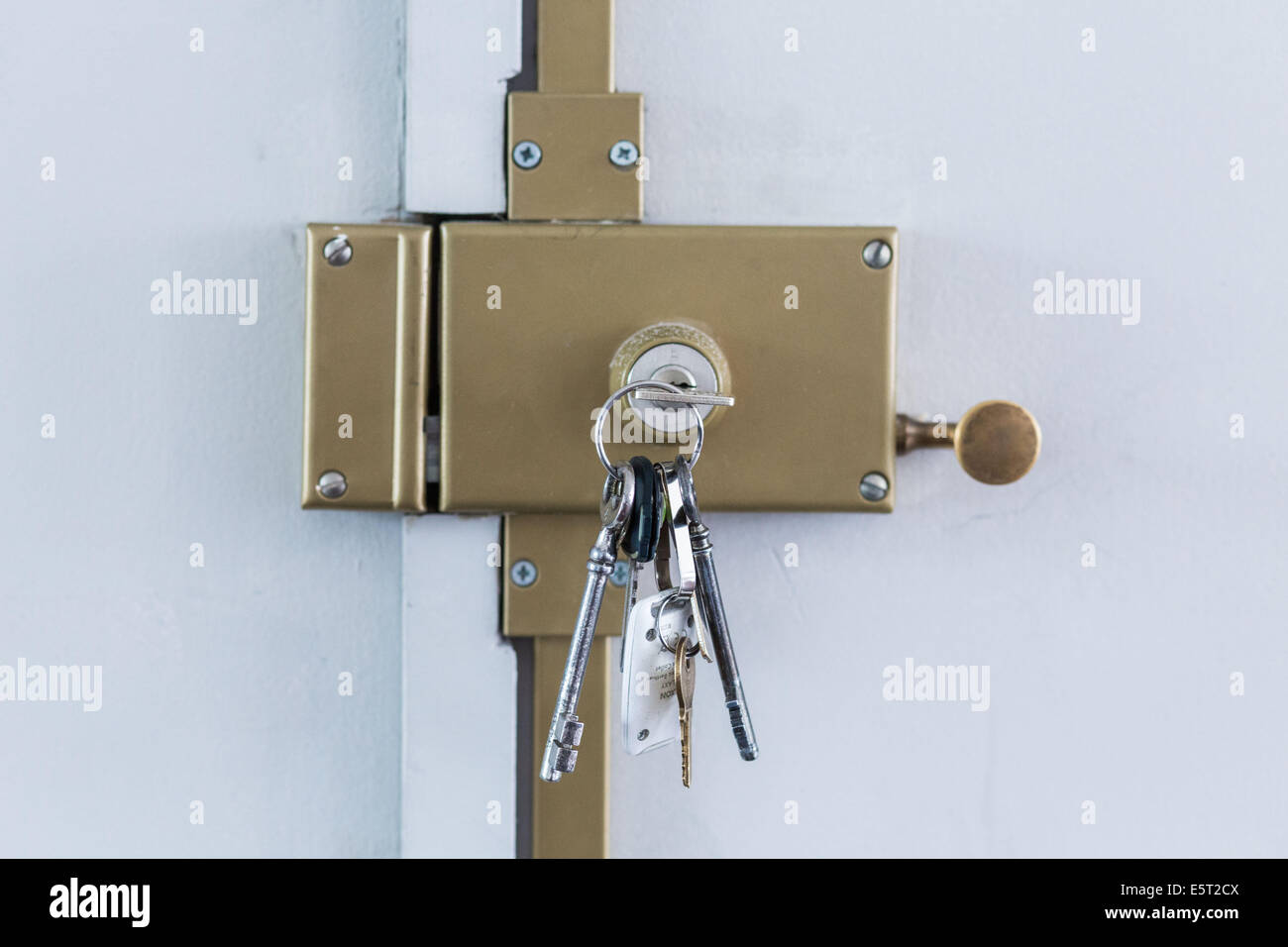 Set of keys on a door lock Stock Photo - Alamy