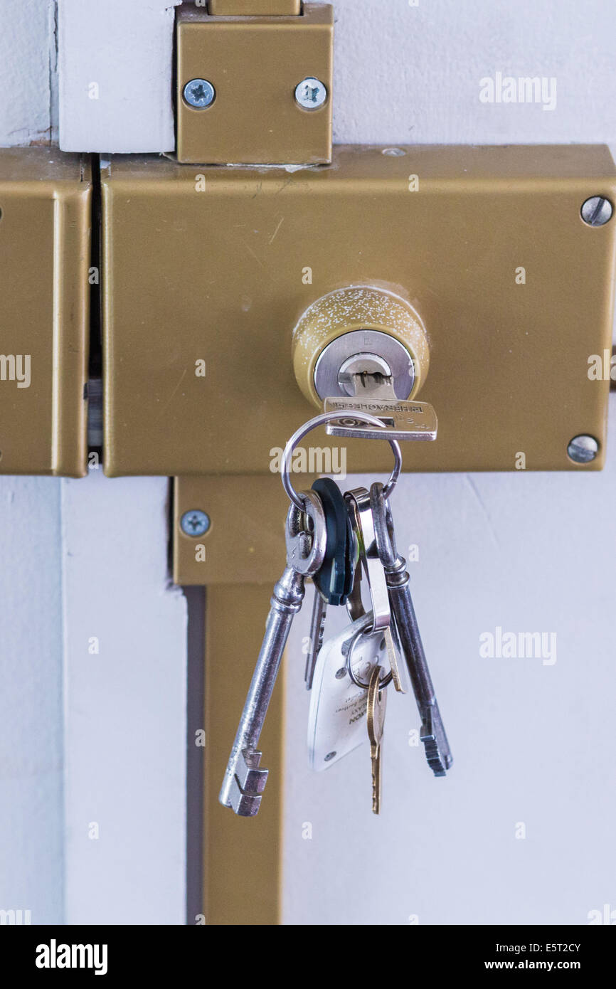 Set of keys on a door lock Stock Photo - Alamy