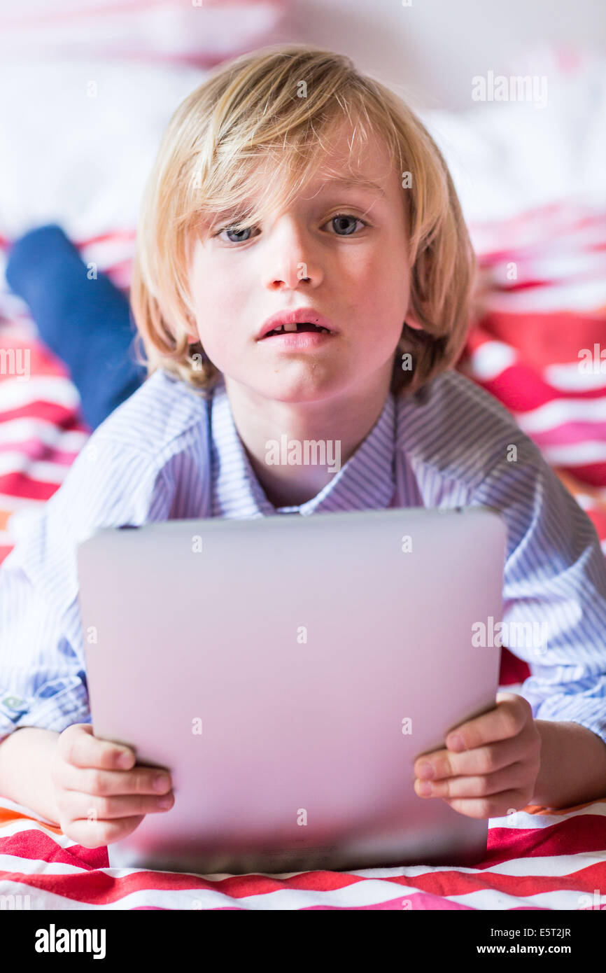 7 year old boy using tablet computer Stock Photo - Alamy