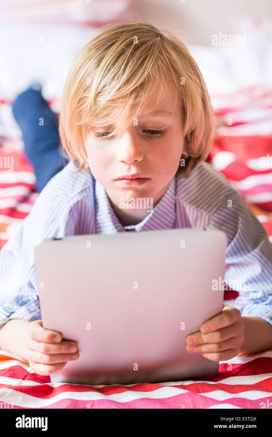7 year old boy using tablet computer Stock Photo - Alamy
