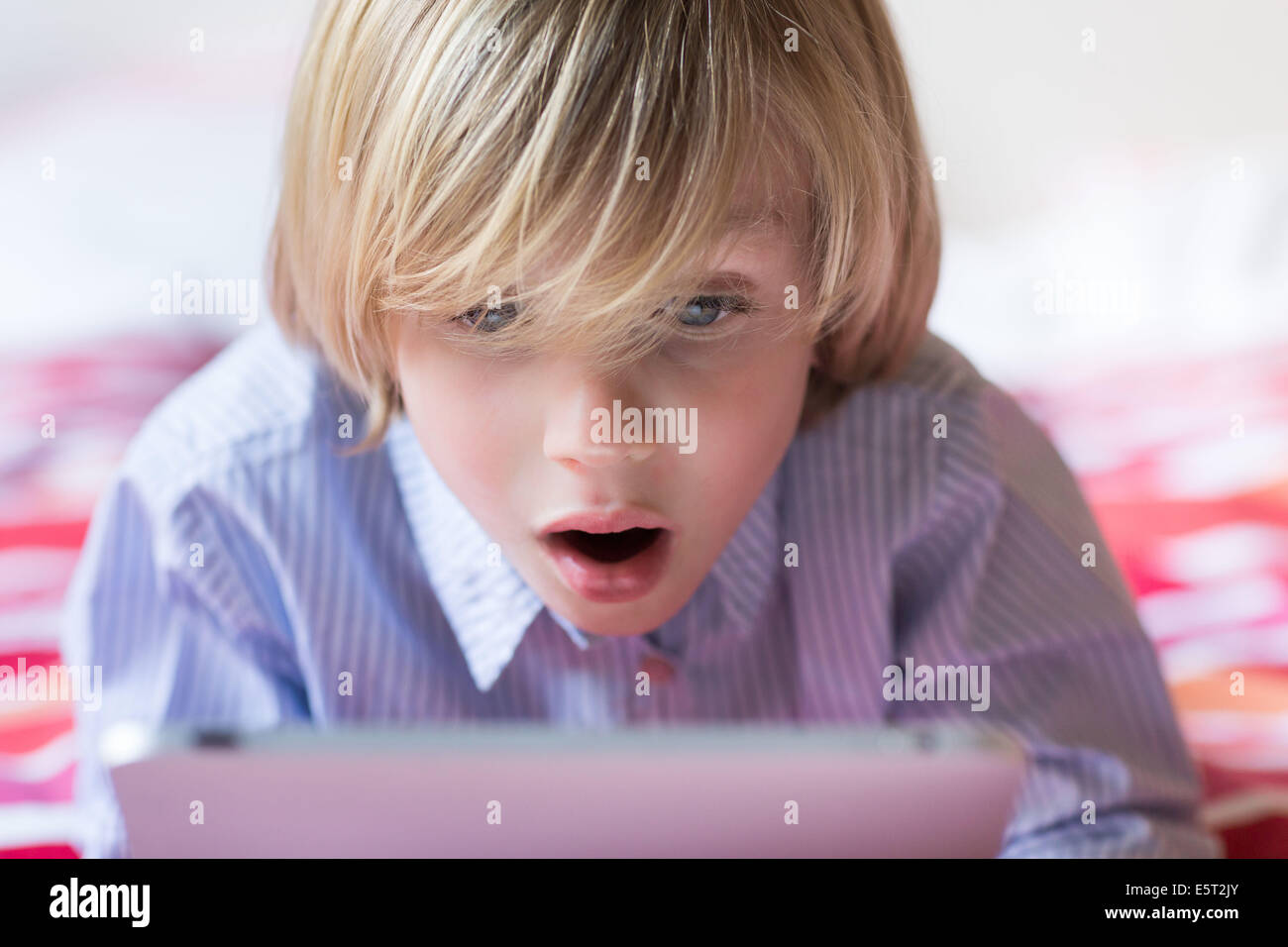 7 year old boy using tablet computer Stock Photo - Alamy