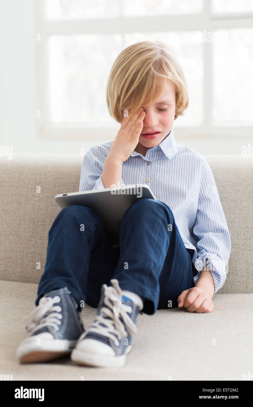 7 year old boy using tablet computer Stock Photo - Alamy