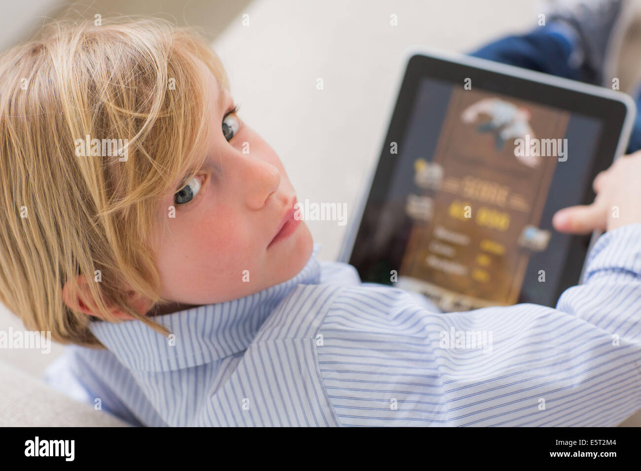 7 year old boy using tablet computer Stock Photo - Alamy