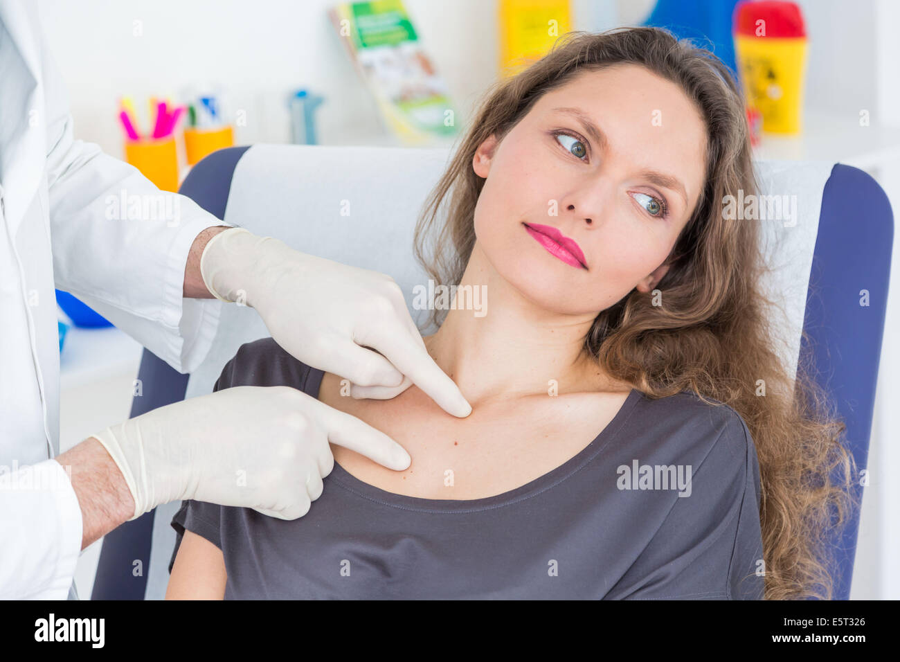 Doctor examining the skin of a woman Stock Photo - Alamy