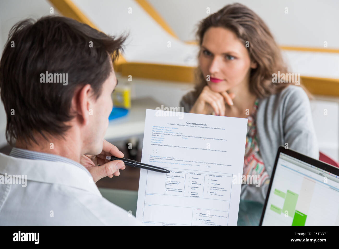 Occupational doctor giving employability document Stock Photo - Alamy