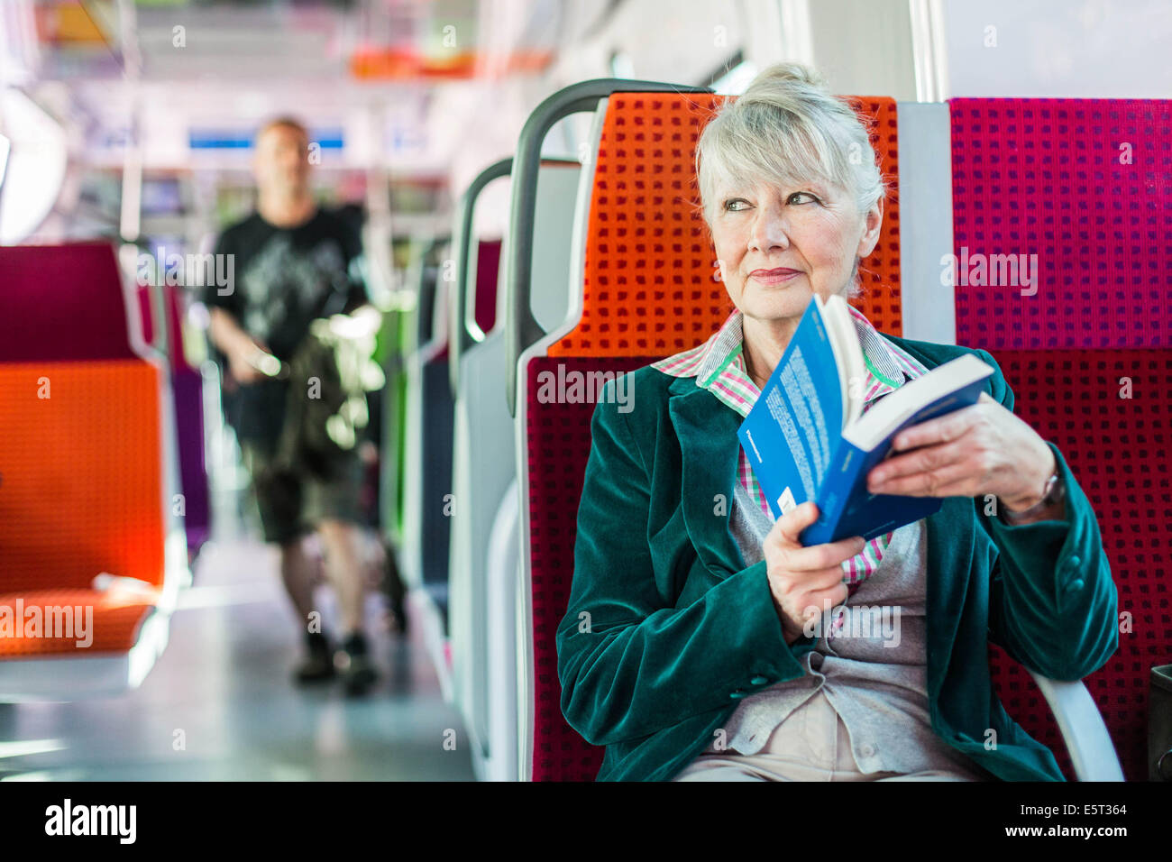 Senior woman in a train Stock Photo - Alamy