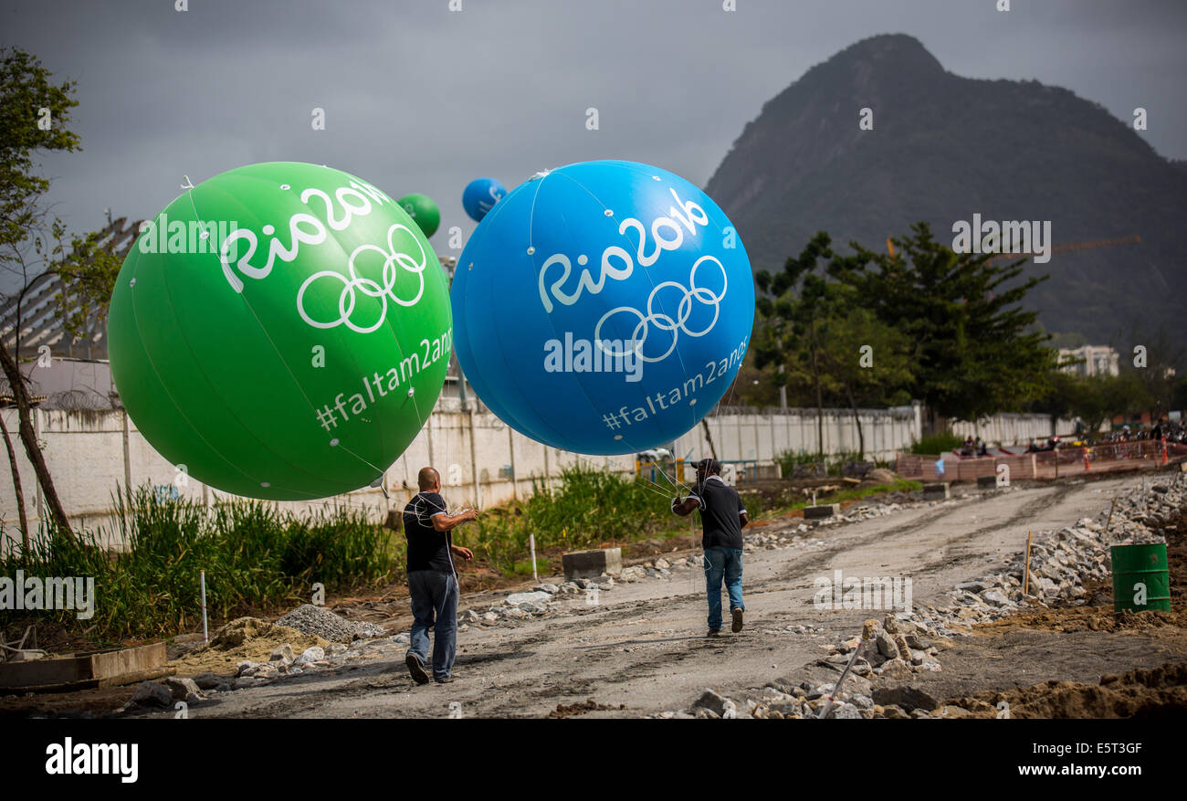 Workers carry huge balloons next to the Olympic Park in Barra two years ...