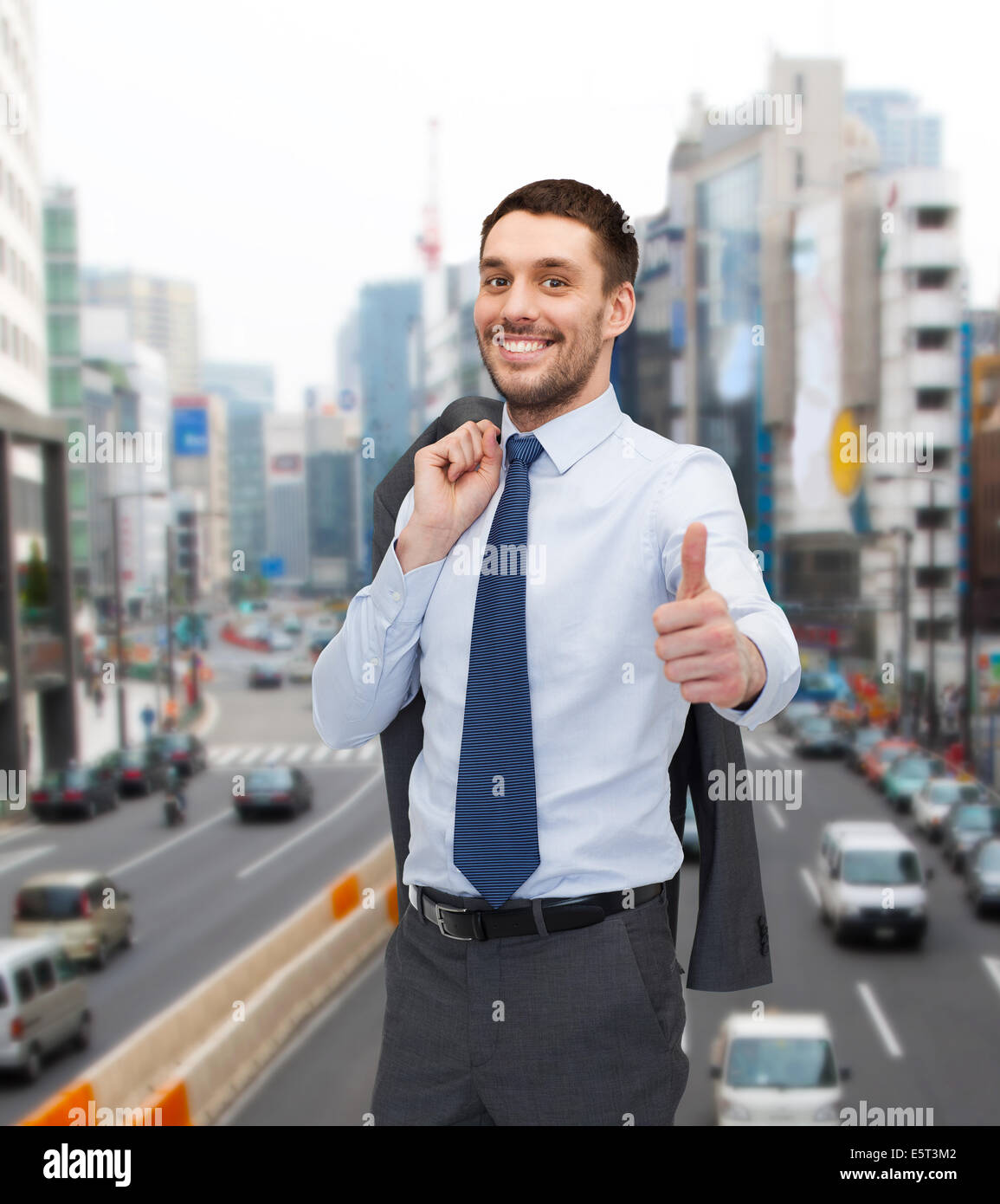 smiling young businessman showing thumbs up Stock Photo - Alamy