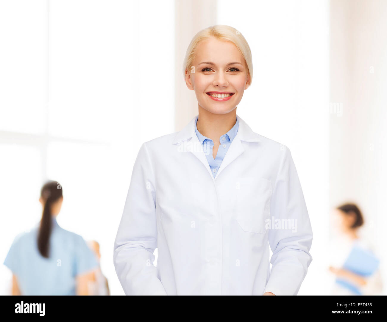 smiling female doctor with group of medics Stock Photo - Alamy