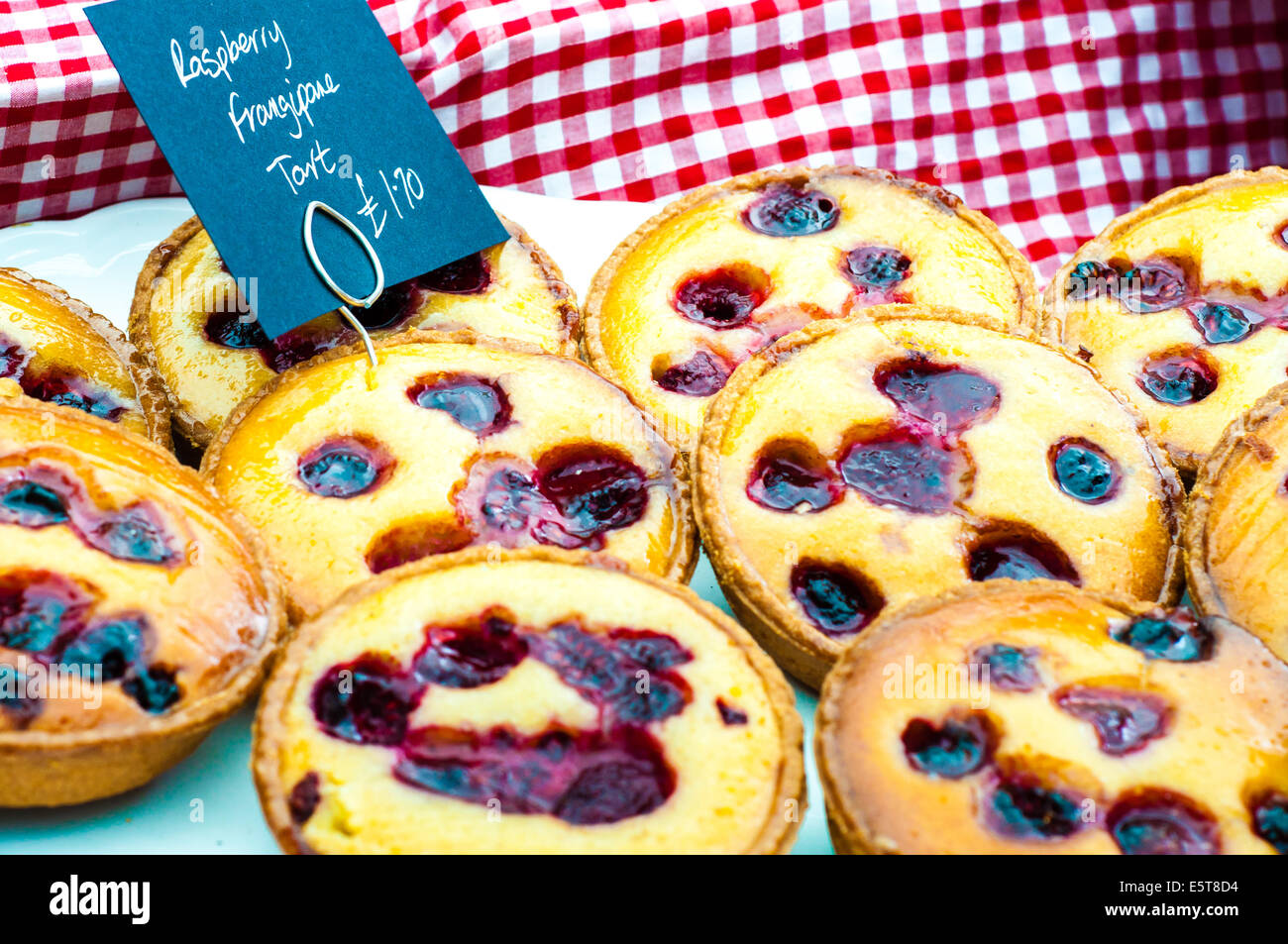 Delicious round raspberry tarts in British market Stock Photo - Alamy