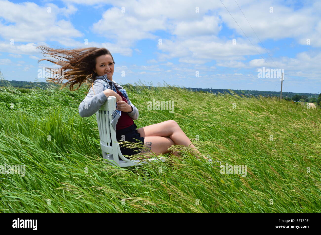 A model poses in the grass in rural Southern Minnesota Stock Photo - Alamy