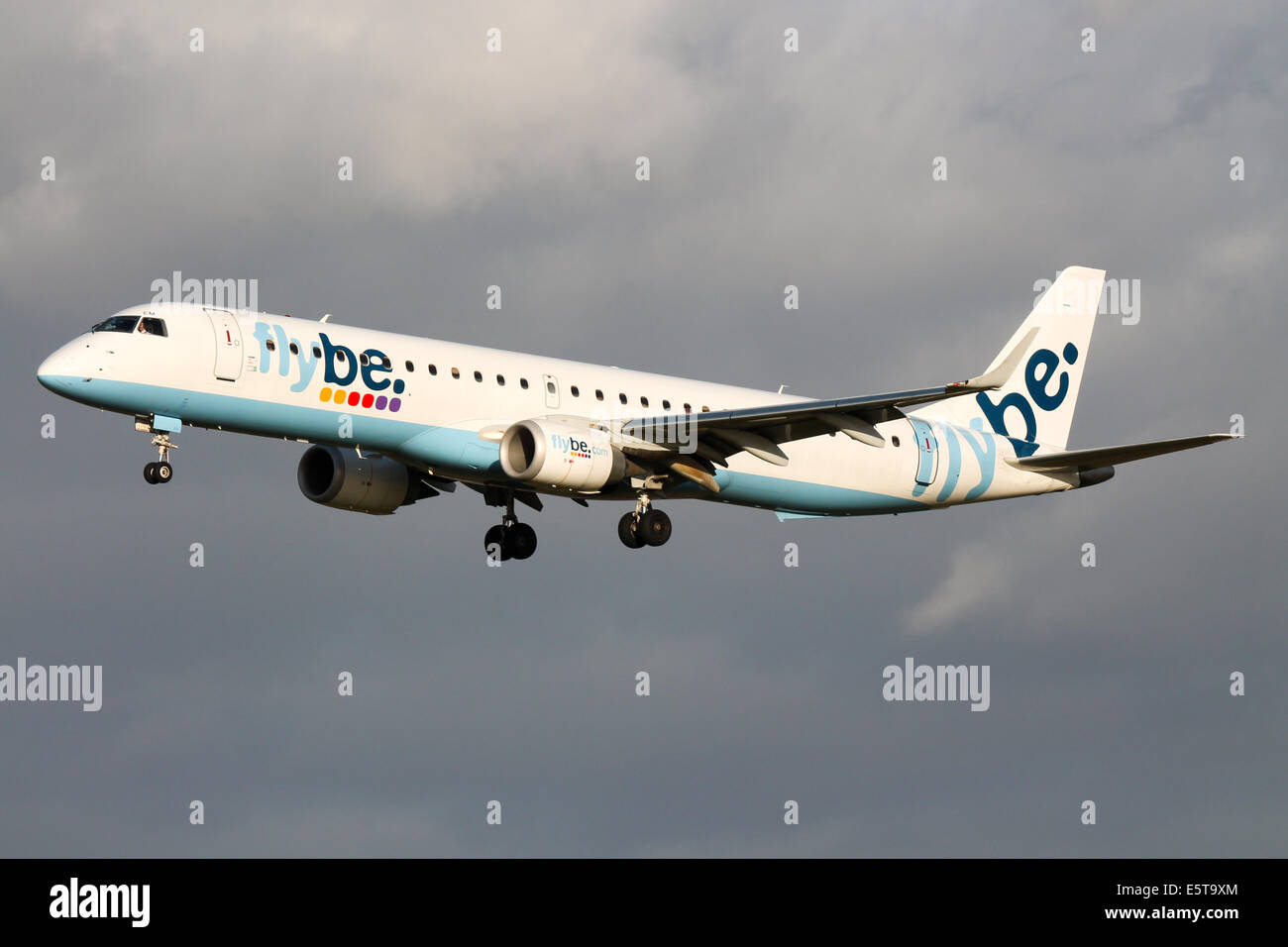 FlyBe Embraer 195 approaches runway 23R at Manchester airport Stock ...