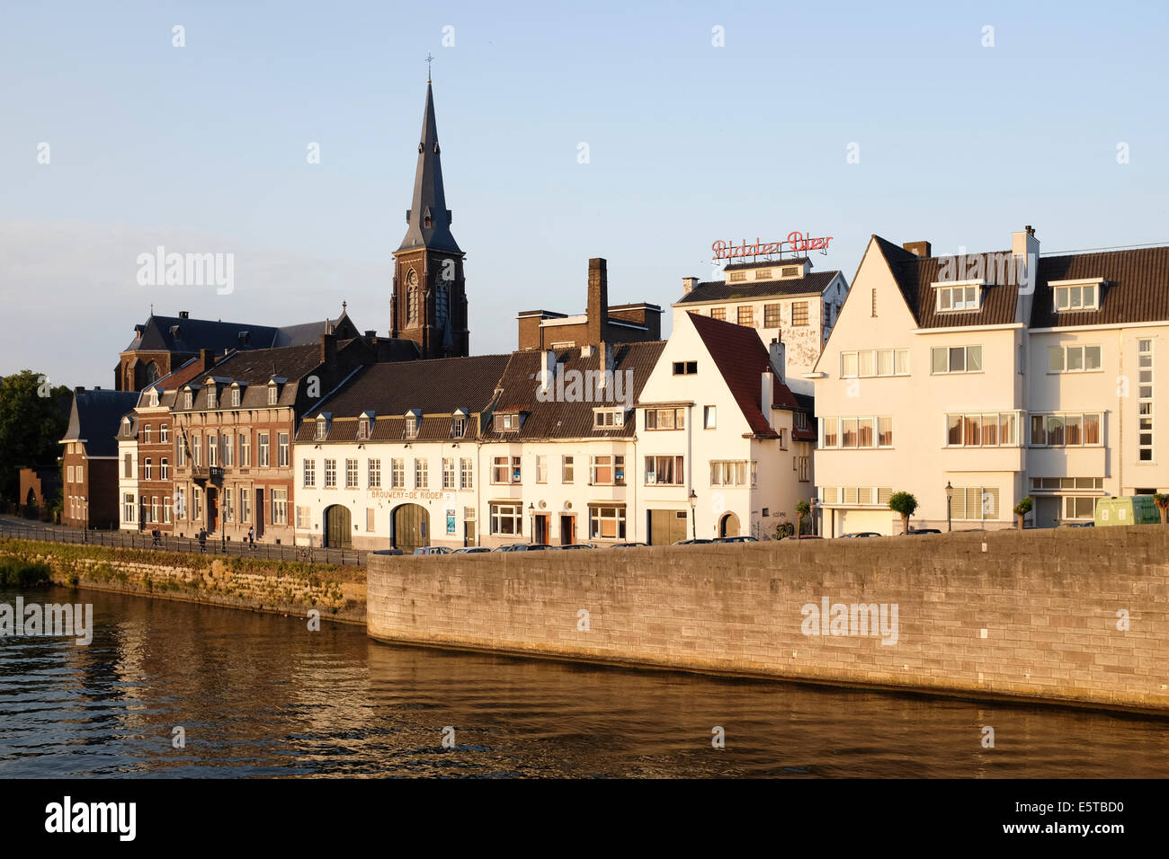 Historic buildings in the riverside Maastricht old town at sunset ...