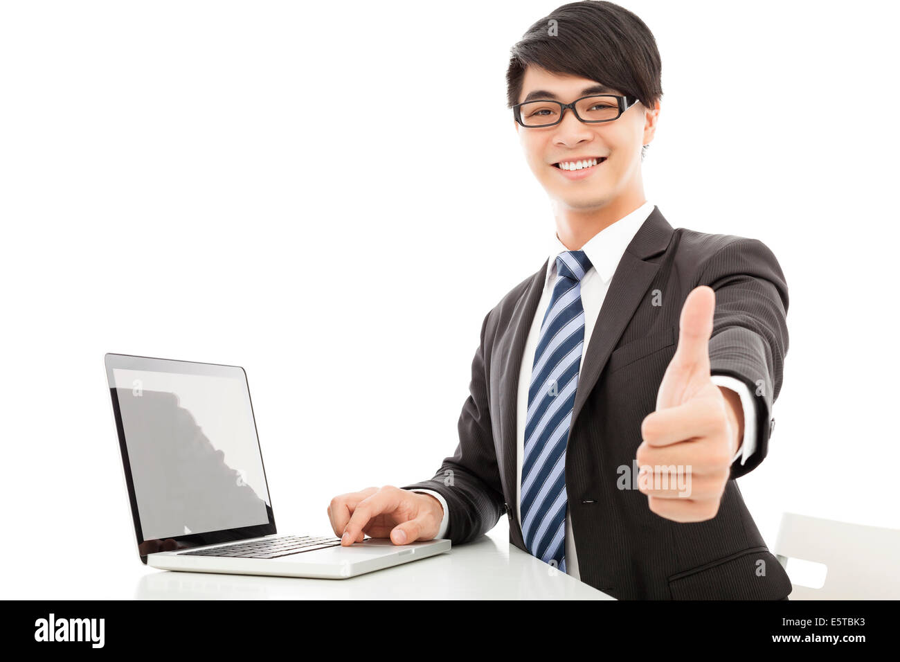 smiling man using laptop and thumb up Stock Photo - Alamy