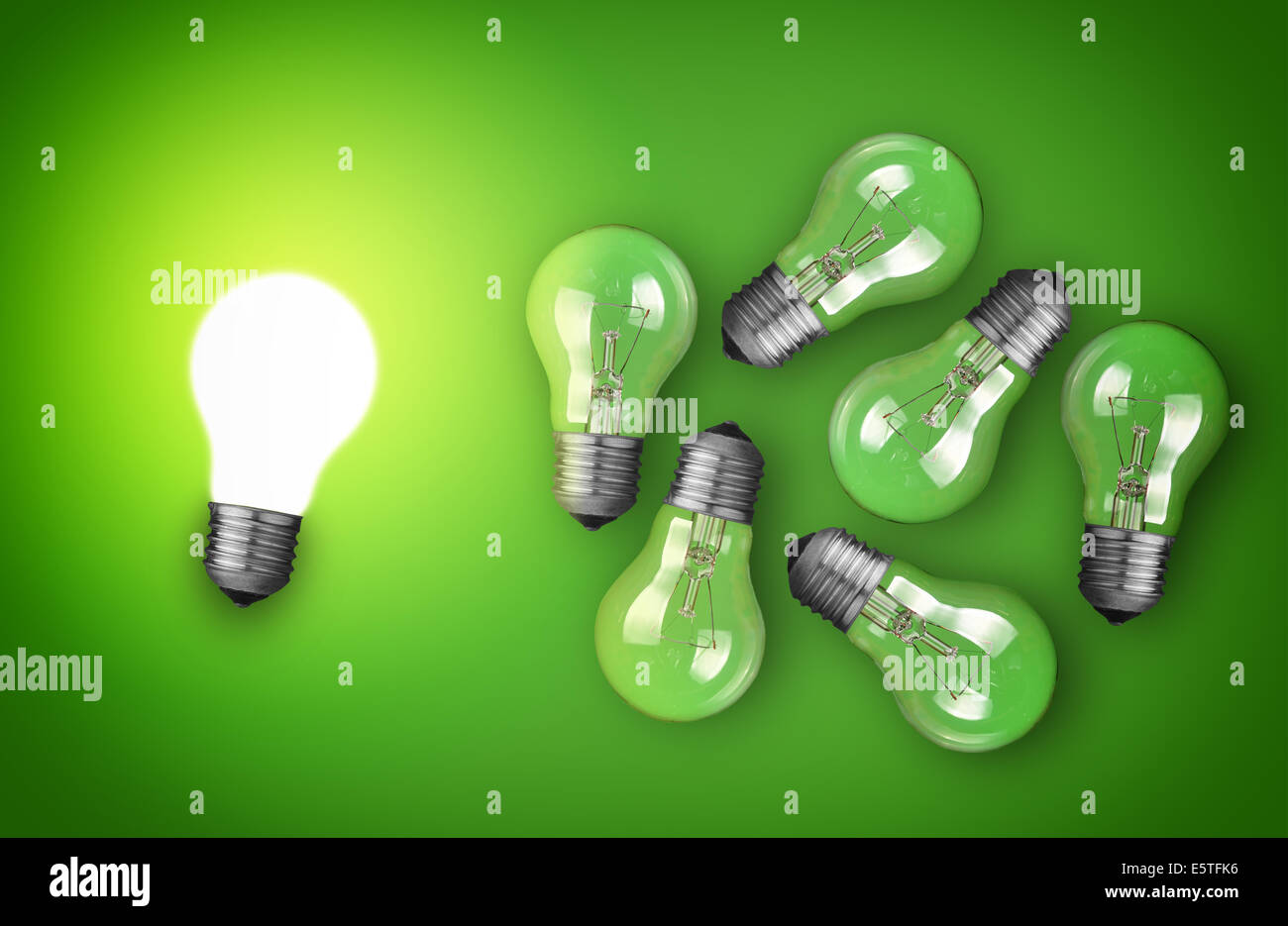 Group of light bulbs on green background Stock Photo - Alamy